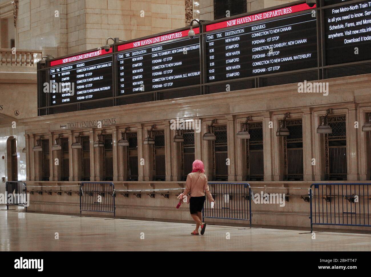 New York, United States. 27th Apr, 2020. A commuter walks by a row of ...
