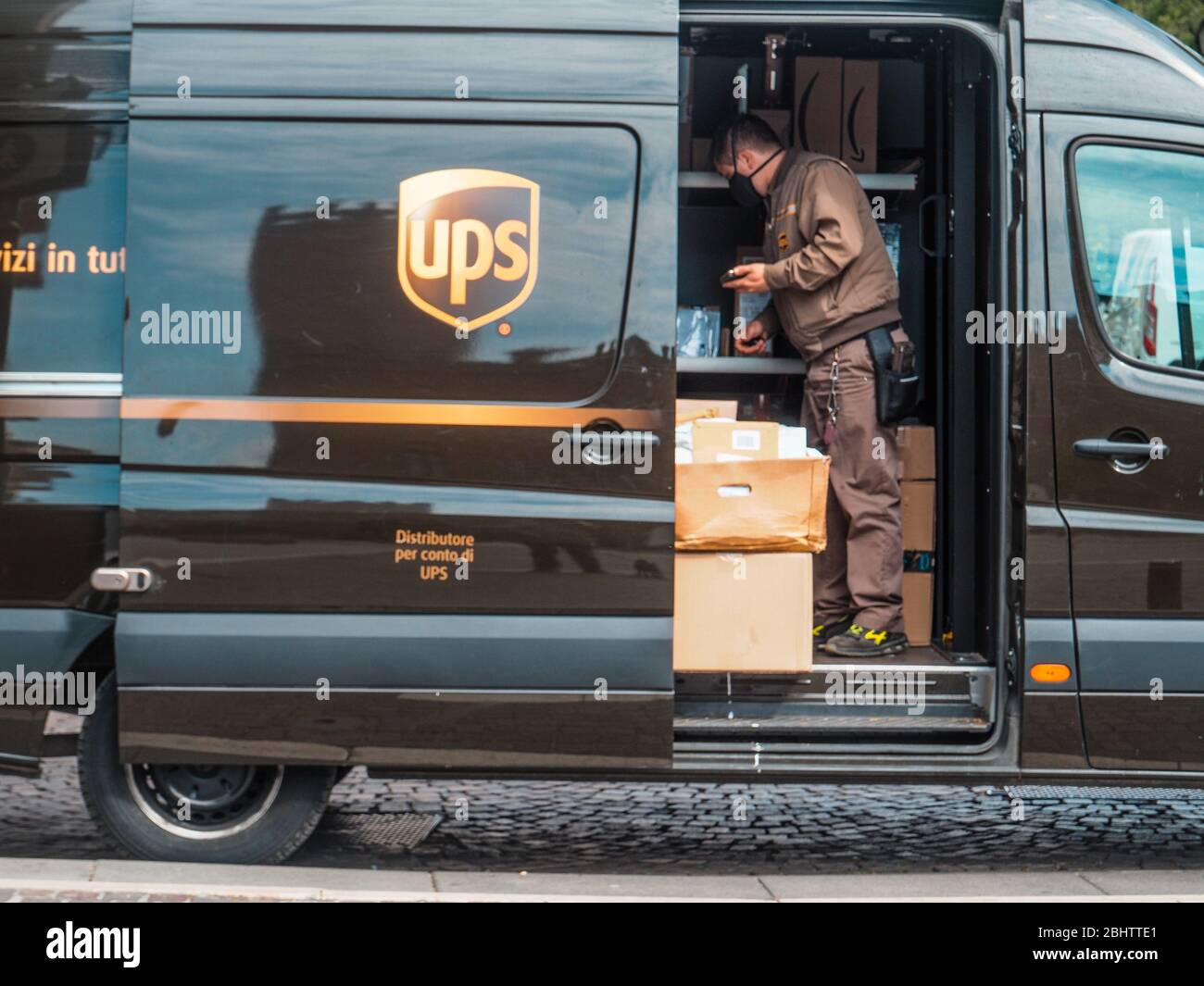 Cremona, Lombardy, Italy - April 26 th and 27th 2020 - a ups courier ...