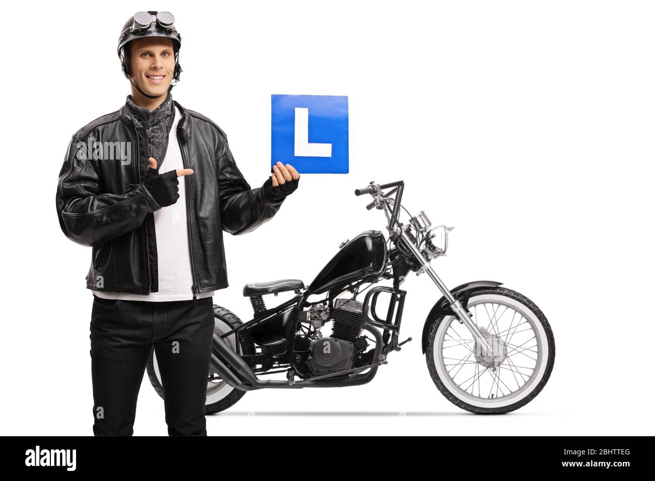 Biker holding a drivers learning plate and standing next to a chopper ...
