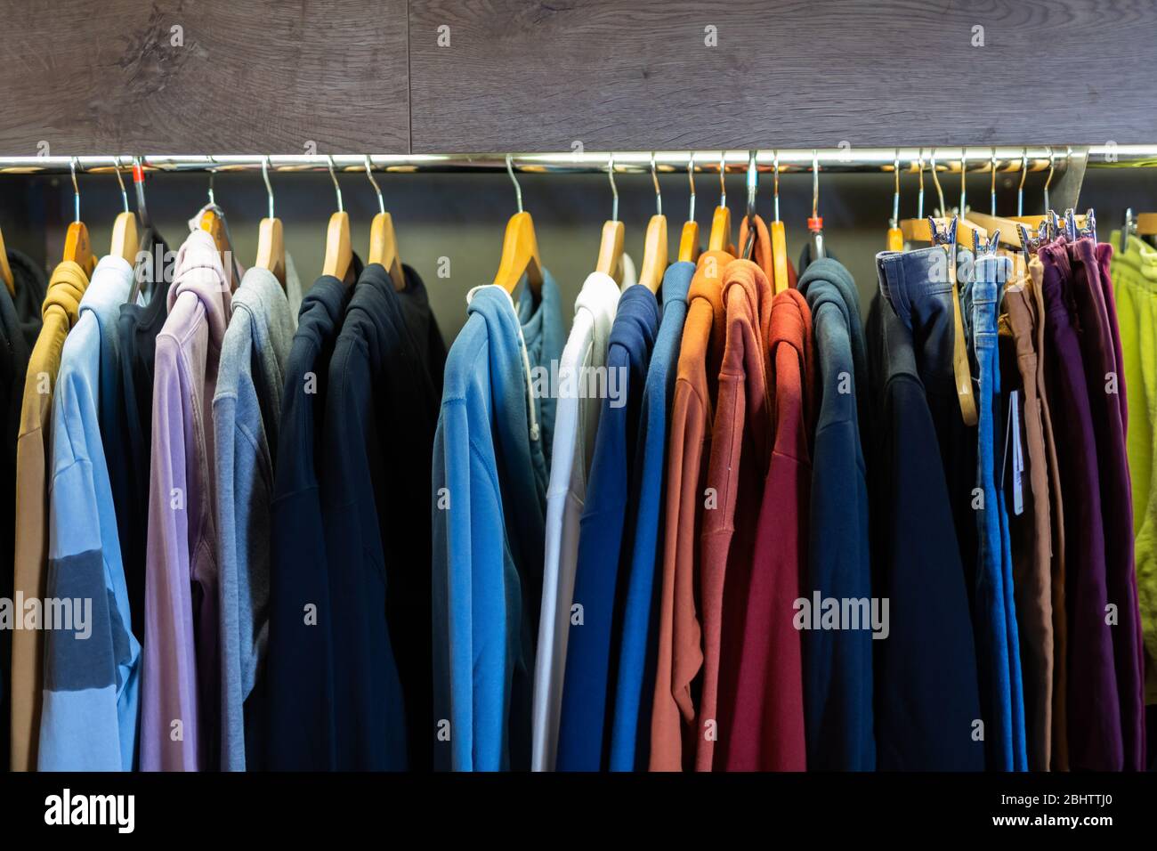 Assortment of summer and autumn clothing in modern garment store ...