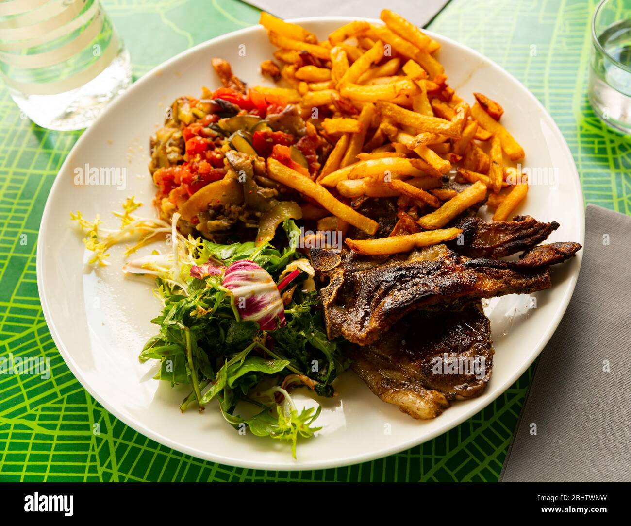 French dish, grilled lamb ribs served with french fries, fresh greens ...