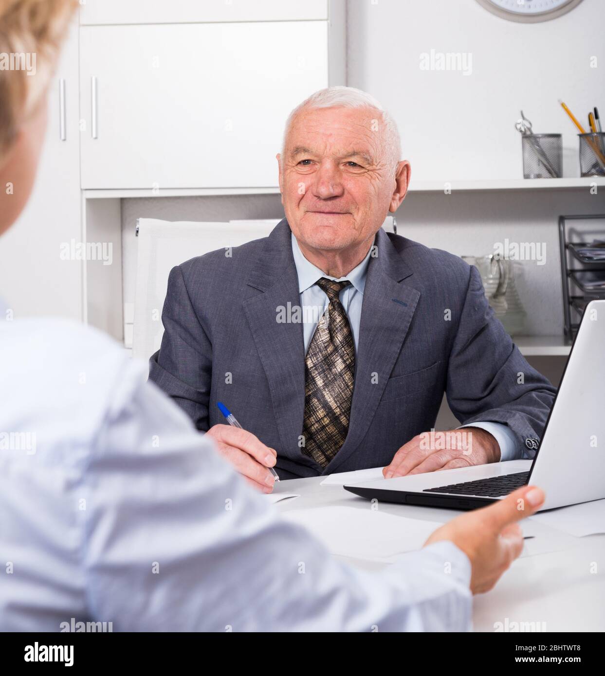 Smiling man manager talking with important client in his office Stock ...