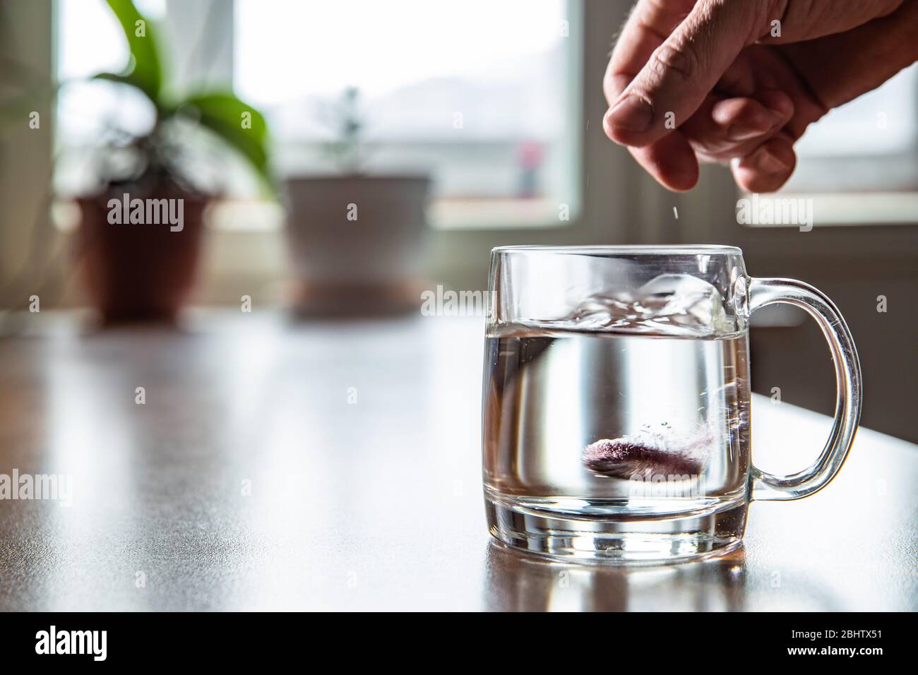 Sparkling tablet throw into a glass transparent glass, the glass is on ...
