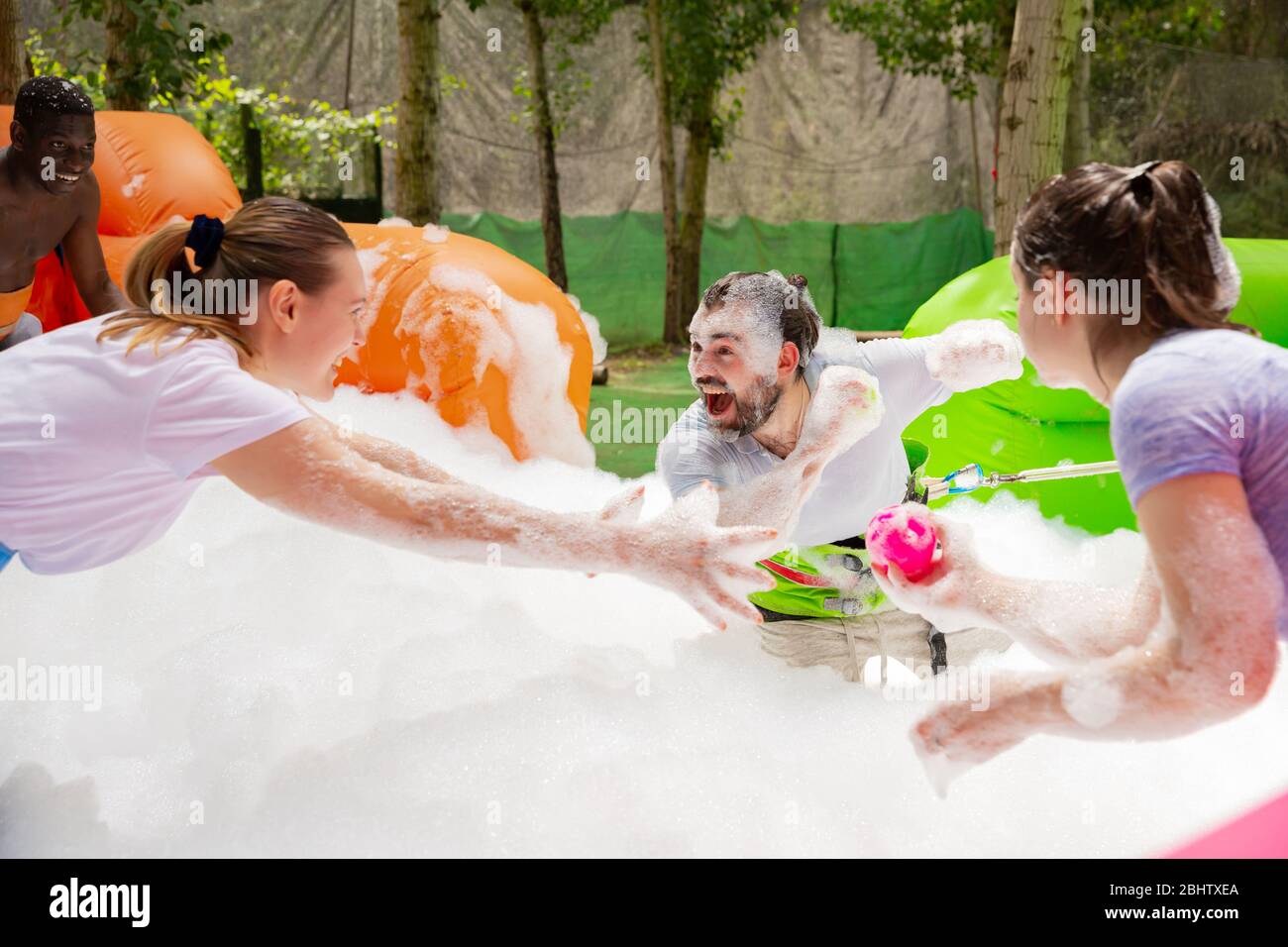 Friendly multiracial team having funny competition in collect of balls ...