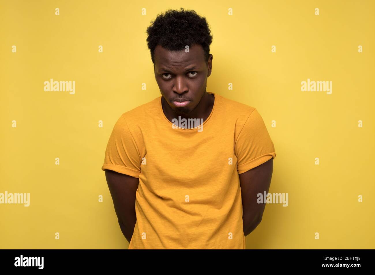 Young african american man looking down with guilty confused expression Stock Photo - Alamy