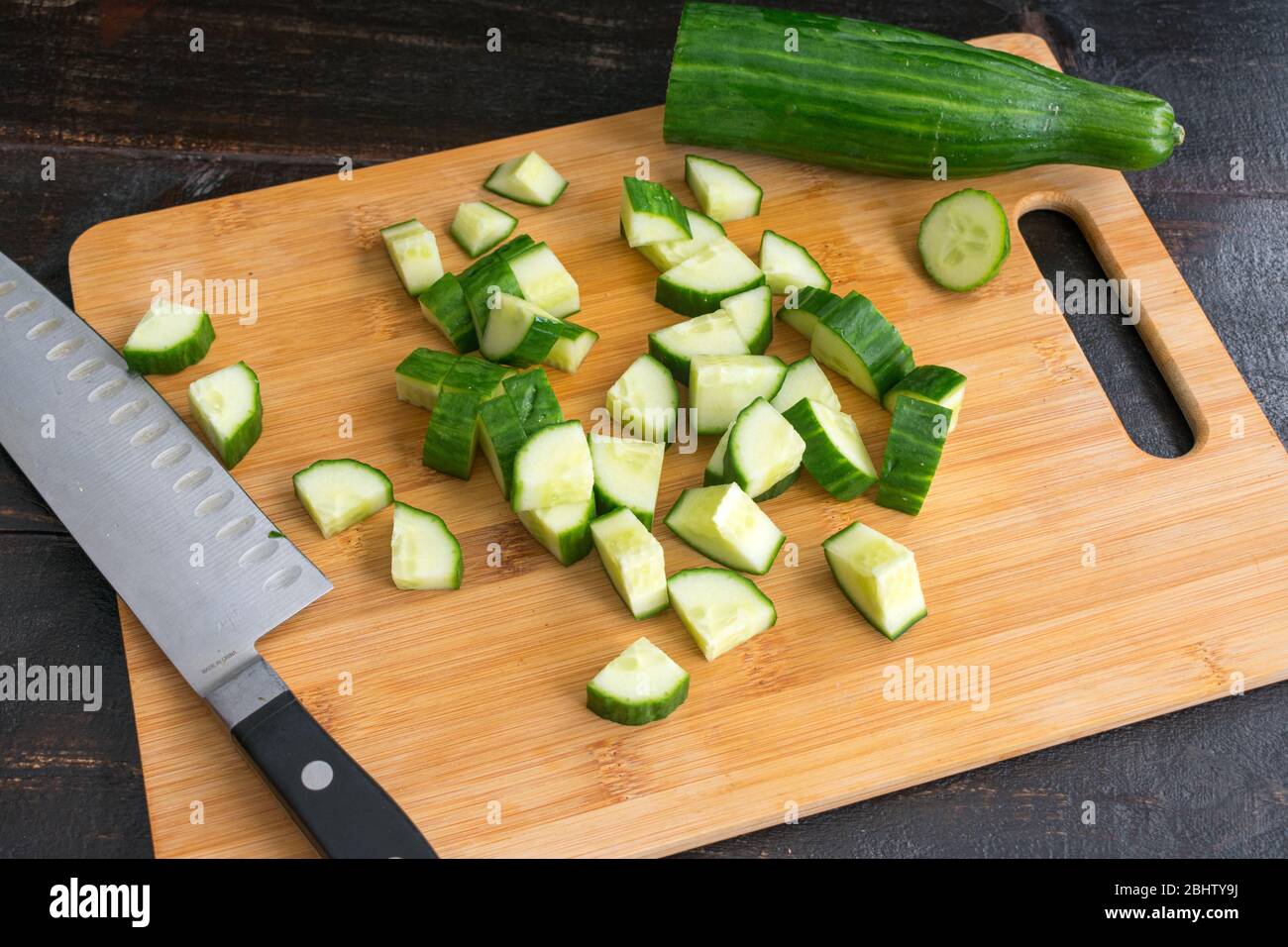 Chopping a Seedless Cucumber: Cutting an English cucumber into chunks ...