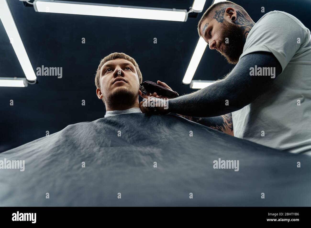 Male barber makes haircut electric hi-res stock photography and images ...