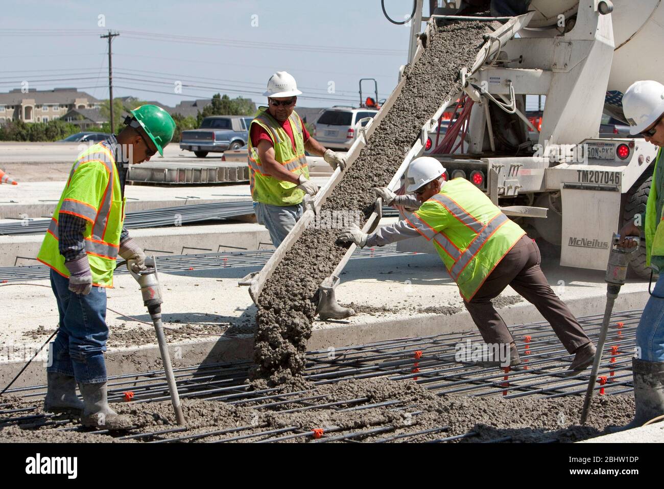 Austin Texas USA, April 6, 2011:Workers pour concrete onto roadway during highway construction ...