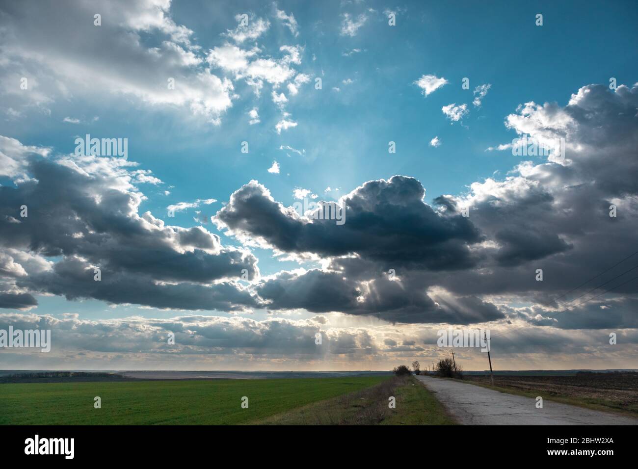 Epic moody spring time countryside fields road with dramatic cloudy sky ...