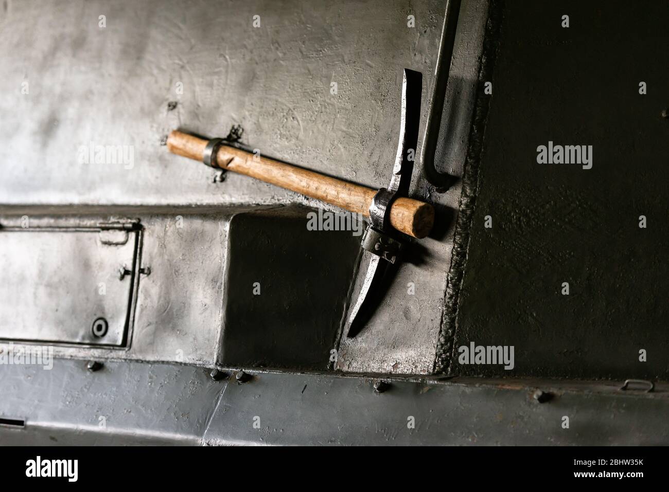 Military equipment of the second world war. Ice axe on the wall of the ...