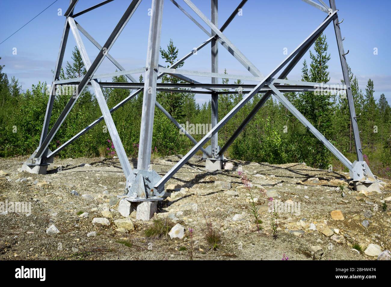 Legs of one of of the steel lattice transmission tower mounted on rocky ...