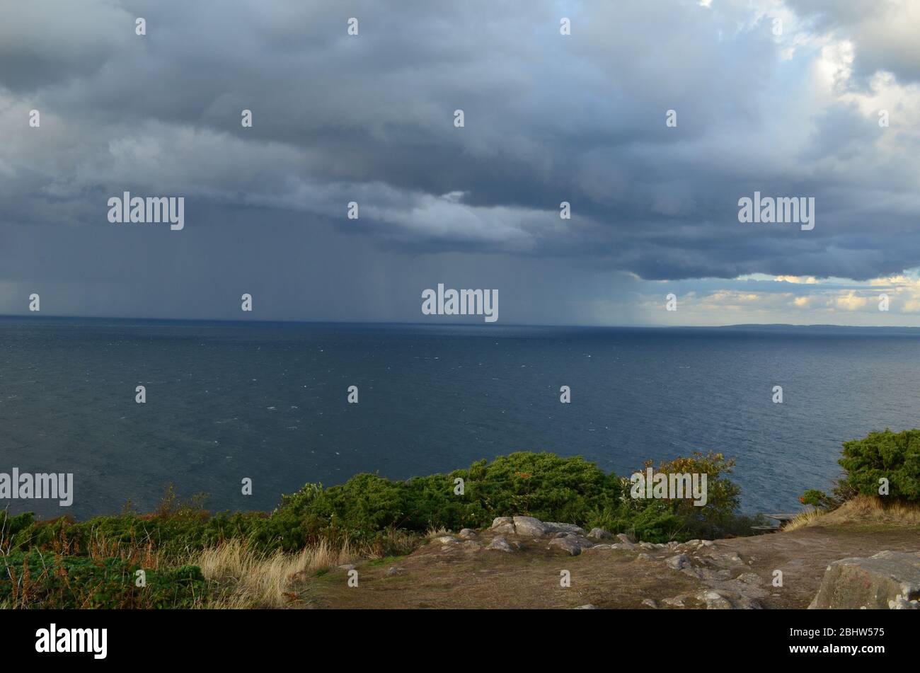 It rains in the sea all over the horizon Stock Photo - Alamy