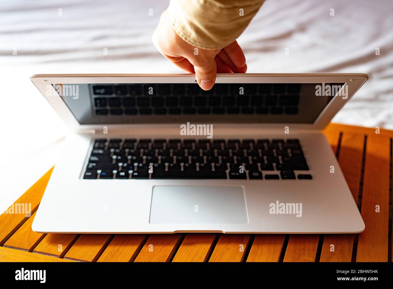 Hand closing the white laptop. Concept of opening and closing the ...