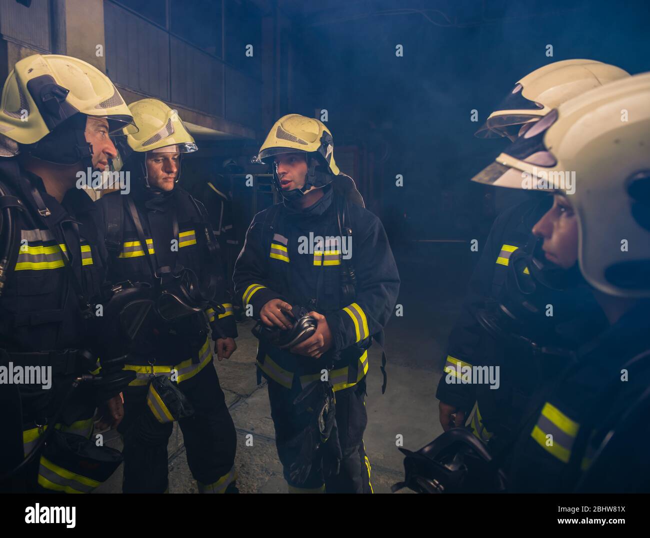 Group of firemen in the fire department organizing action plan for safe ...