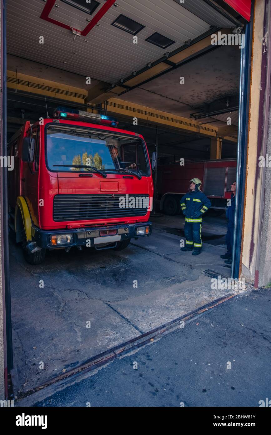 Fire engine inside the garage of the fire department Stock Photo - Alamy