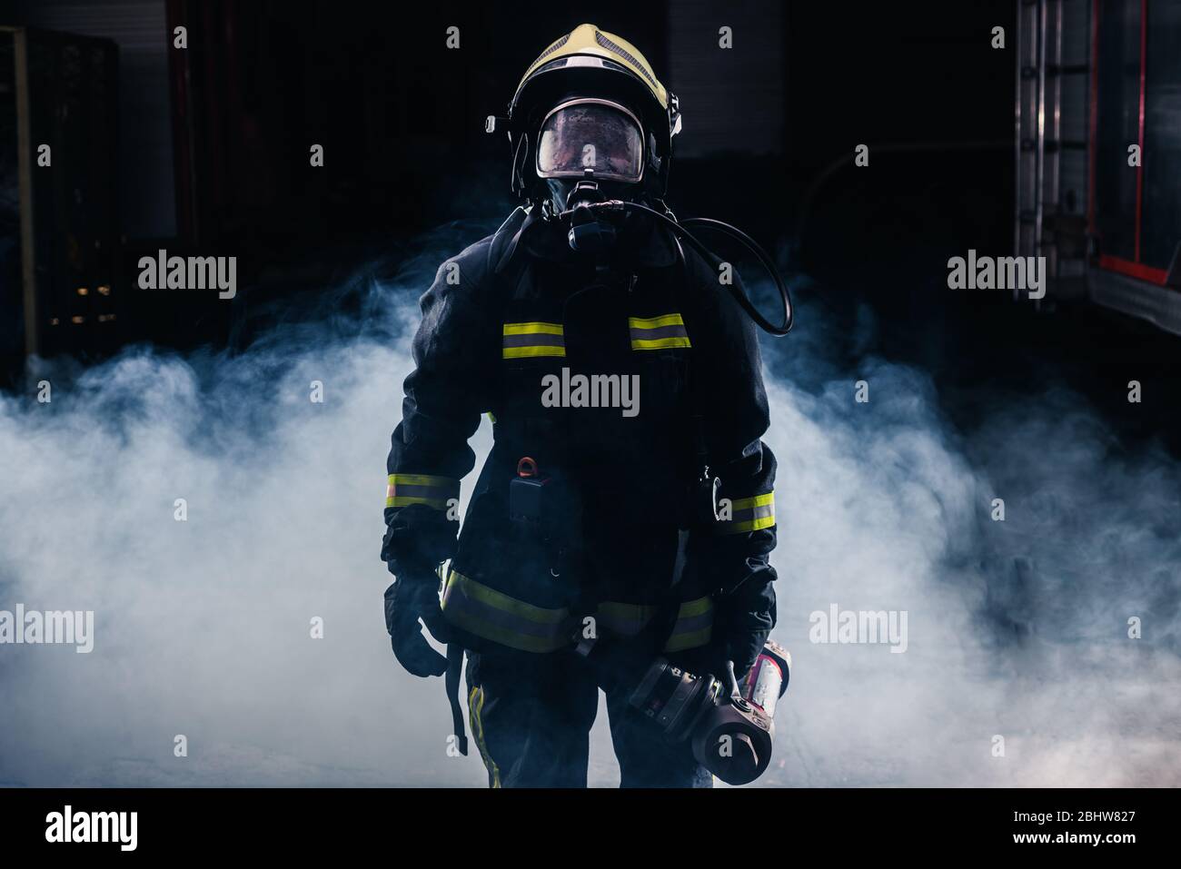 Portrait of a female firefighter wearing a helmet and all safety ...