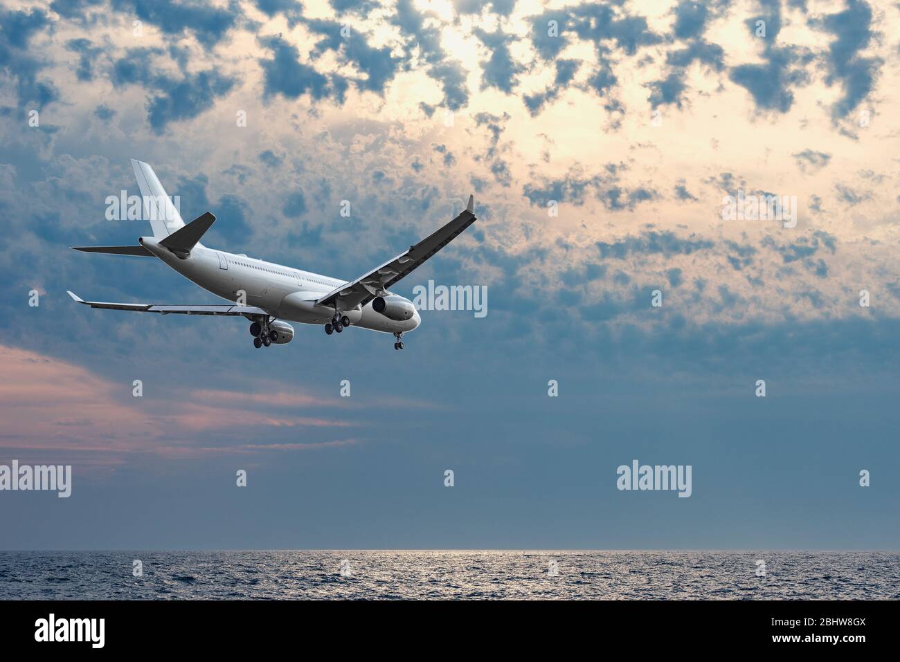 Flight of the plane above the ocean before landing Stock Photo - Alamy