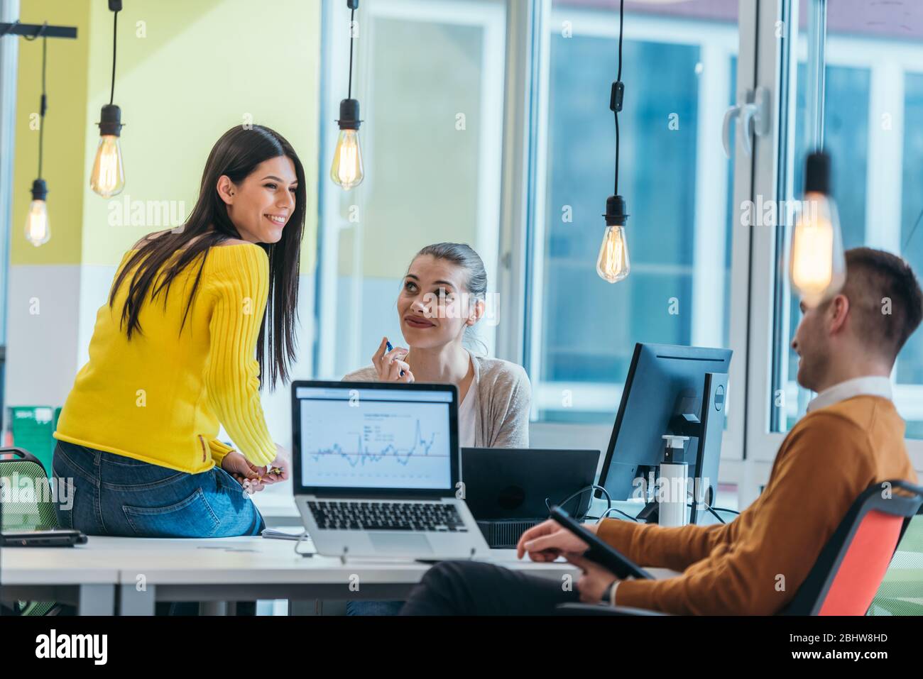 Group of professional coworkers ( team ) working on a desk in a modern ...