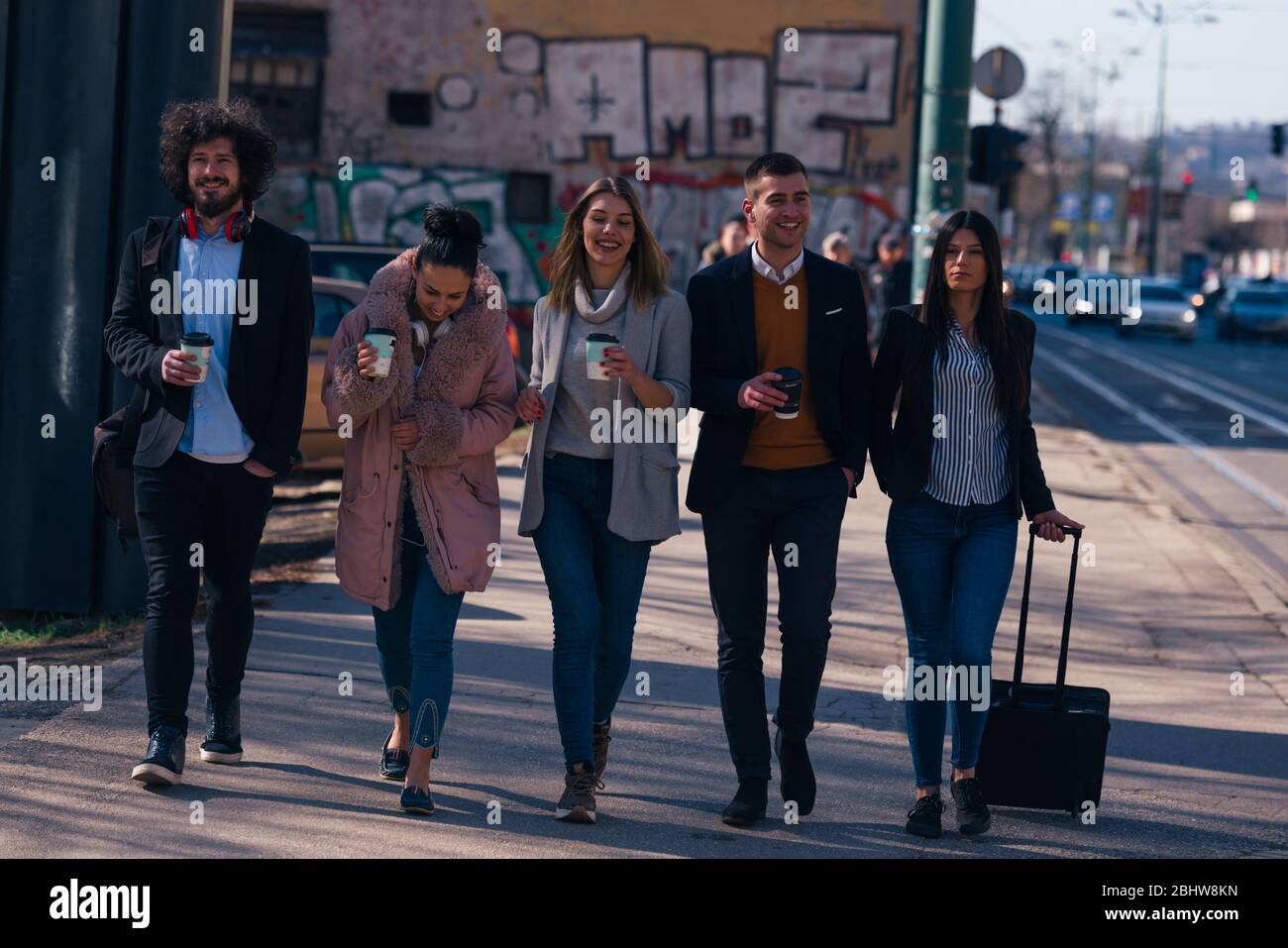 Group of friends (colleagues) hanging out in an urban area Stock Photo ...