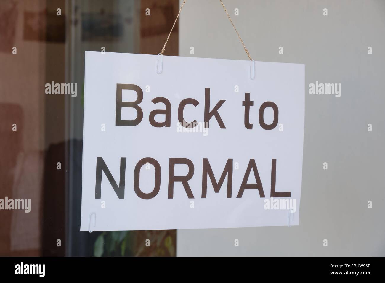 'Back to normal' sign hanging from a store window after Coronavirus ...