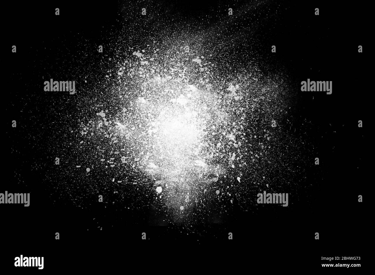 Freeze motion of white powder exploding, isolated on black, dark ...