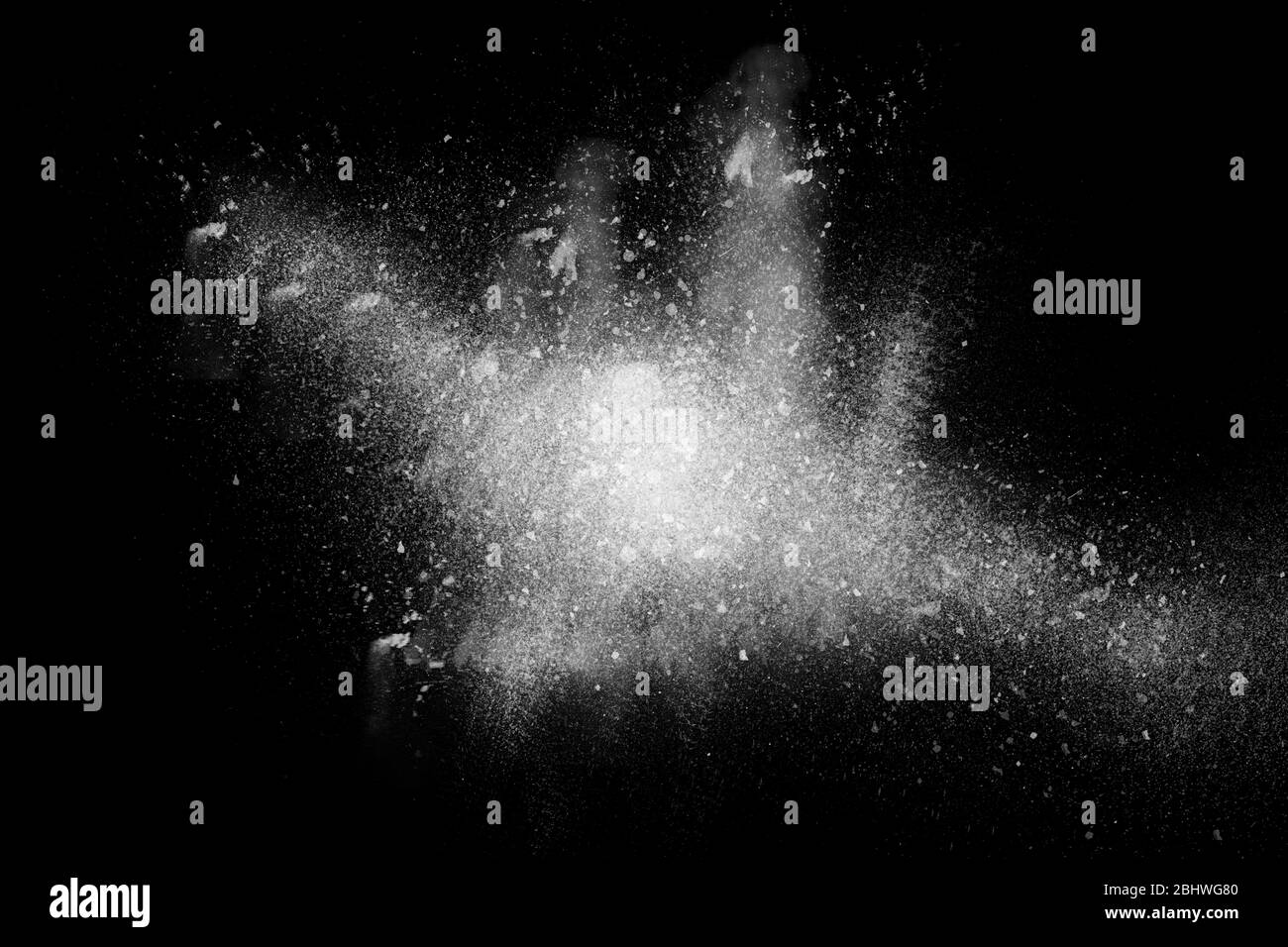 Freeze motion of white powder exploding, isolated on black, dark ...