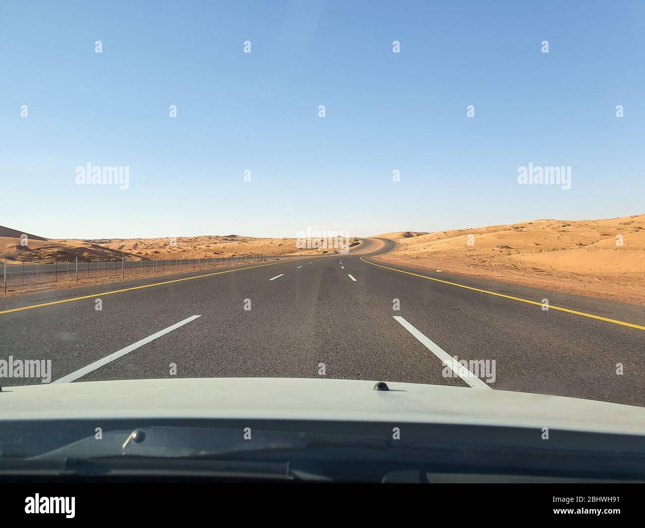 Empty desert highway surrounded by sand dunes in Saudi Arabia Stock ...