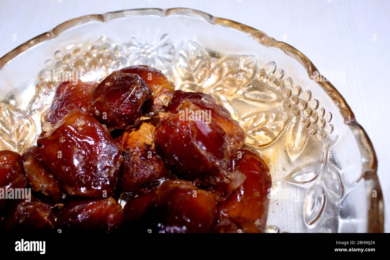 delicious dried date palm fruits cut pieces in glass bowl Stock Photo ...