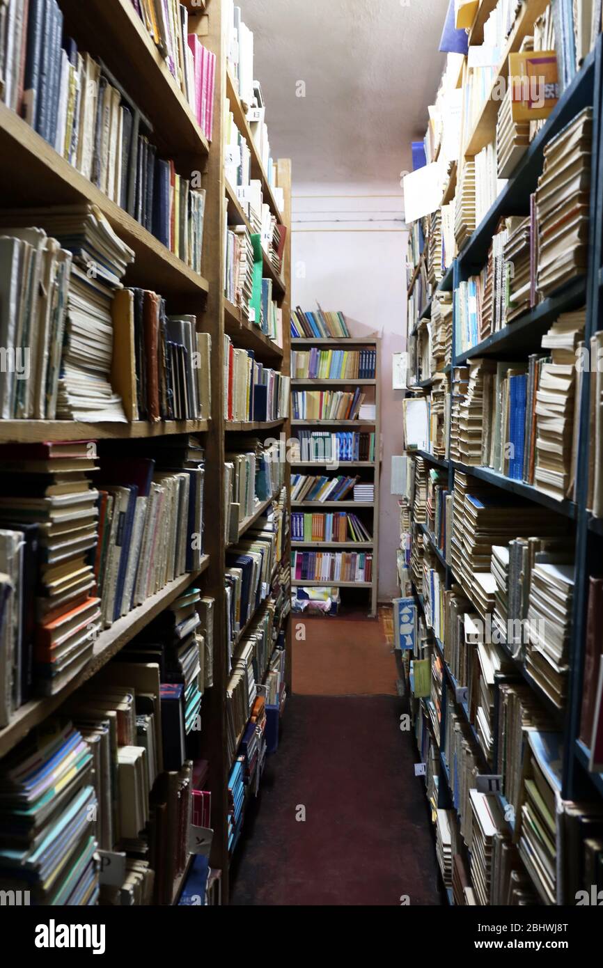 Many books on bookshelf in library Stock Photo - Alamy