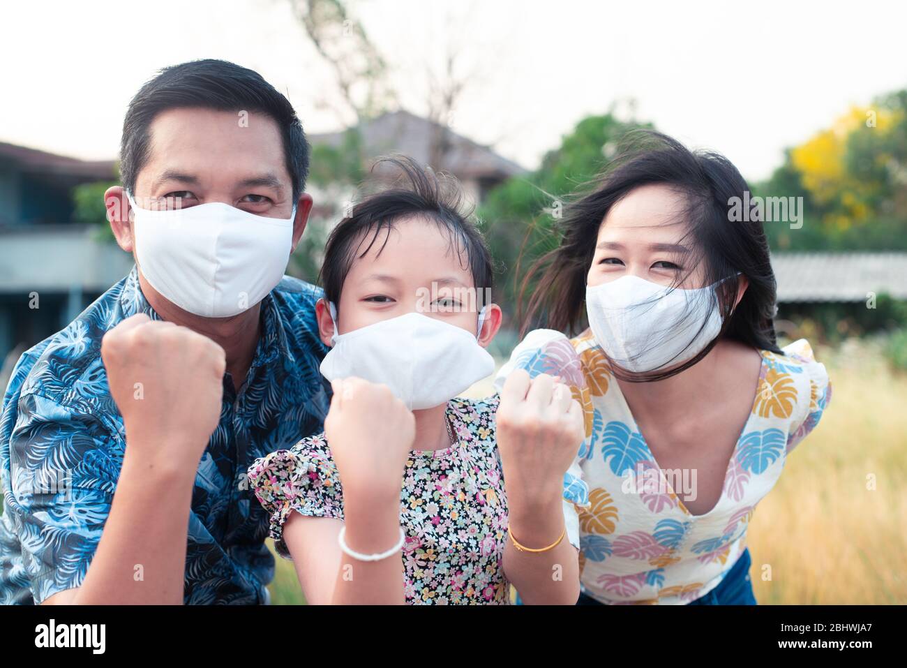 Power of family with father mother and daughter wearing medical face ...