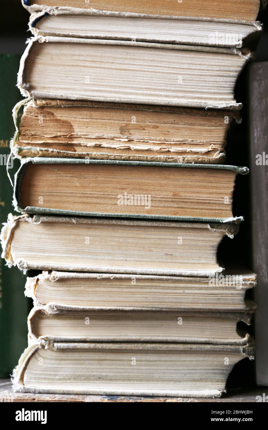 Stack of books on bookshelf, closeup Stock Photo - Alamy