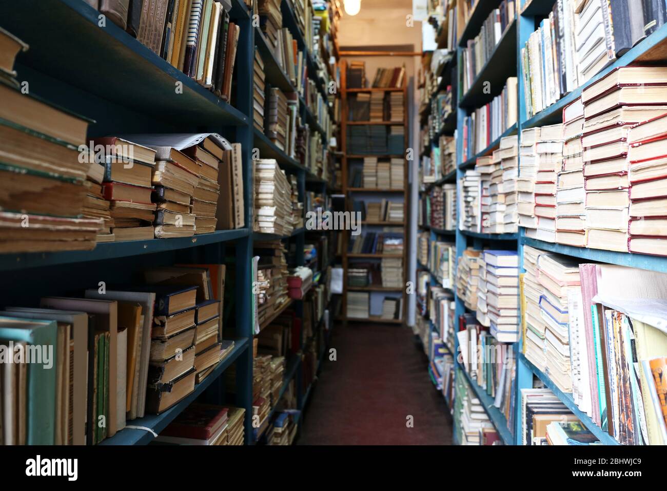 Many books on bookshelf in library Stock Photo - Alamy