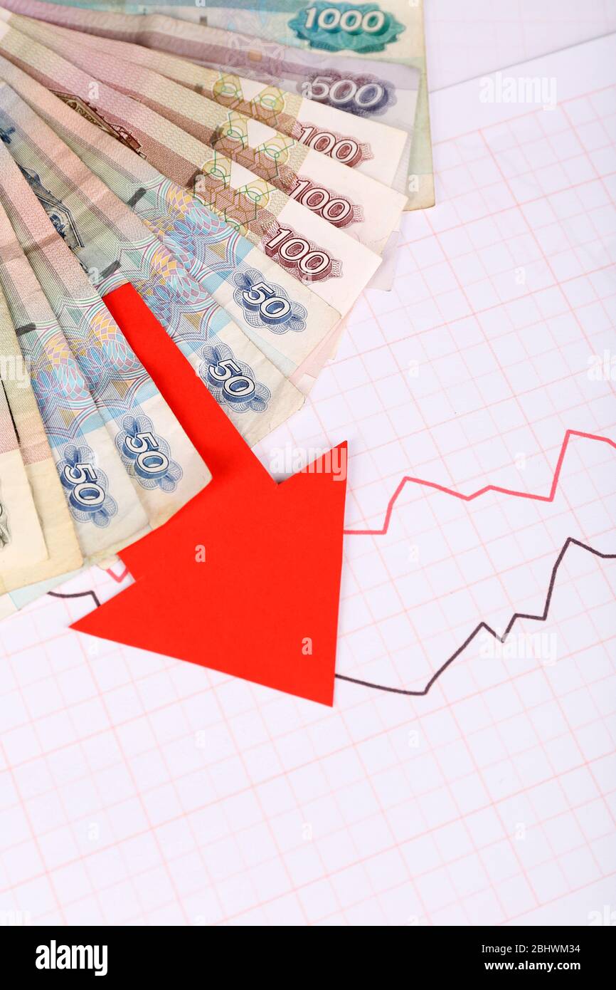 Money and red arrow on graph document close up Stock Photo - Alamy