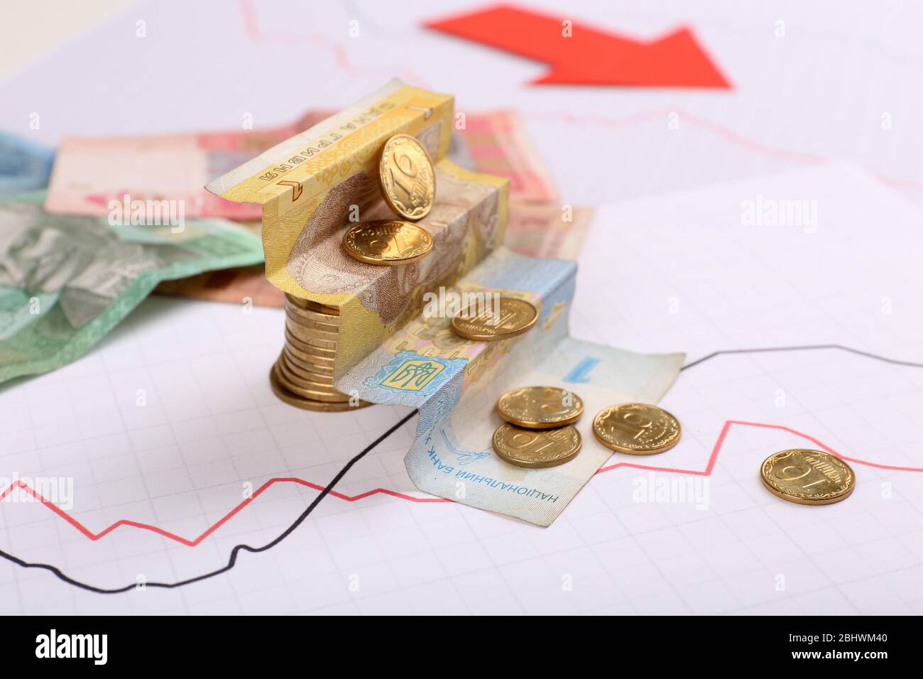 Money and red arrow on graph document close up Stock Photo - Alamy