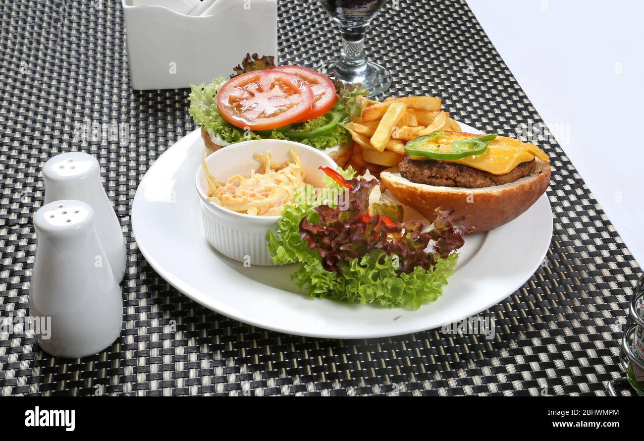Open Burger plate served with coleslaw and french fries Stock Photo - Alamy