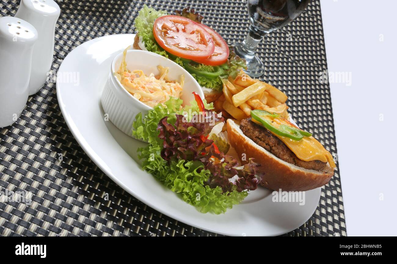Open Burger plate served with coleslaw and french fries Stock Photo - Alamy