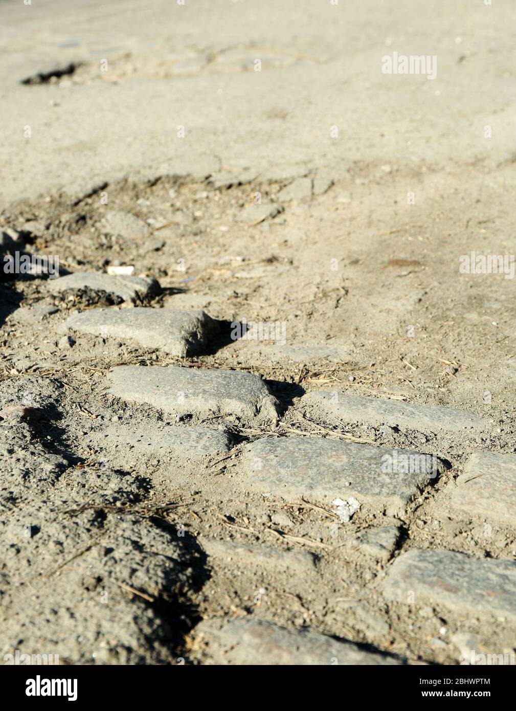 Very bad quality road with potholes Stock Photo - Alamy