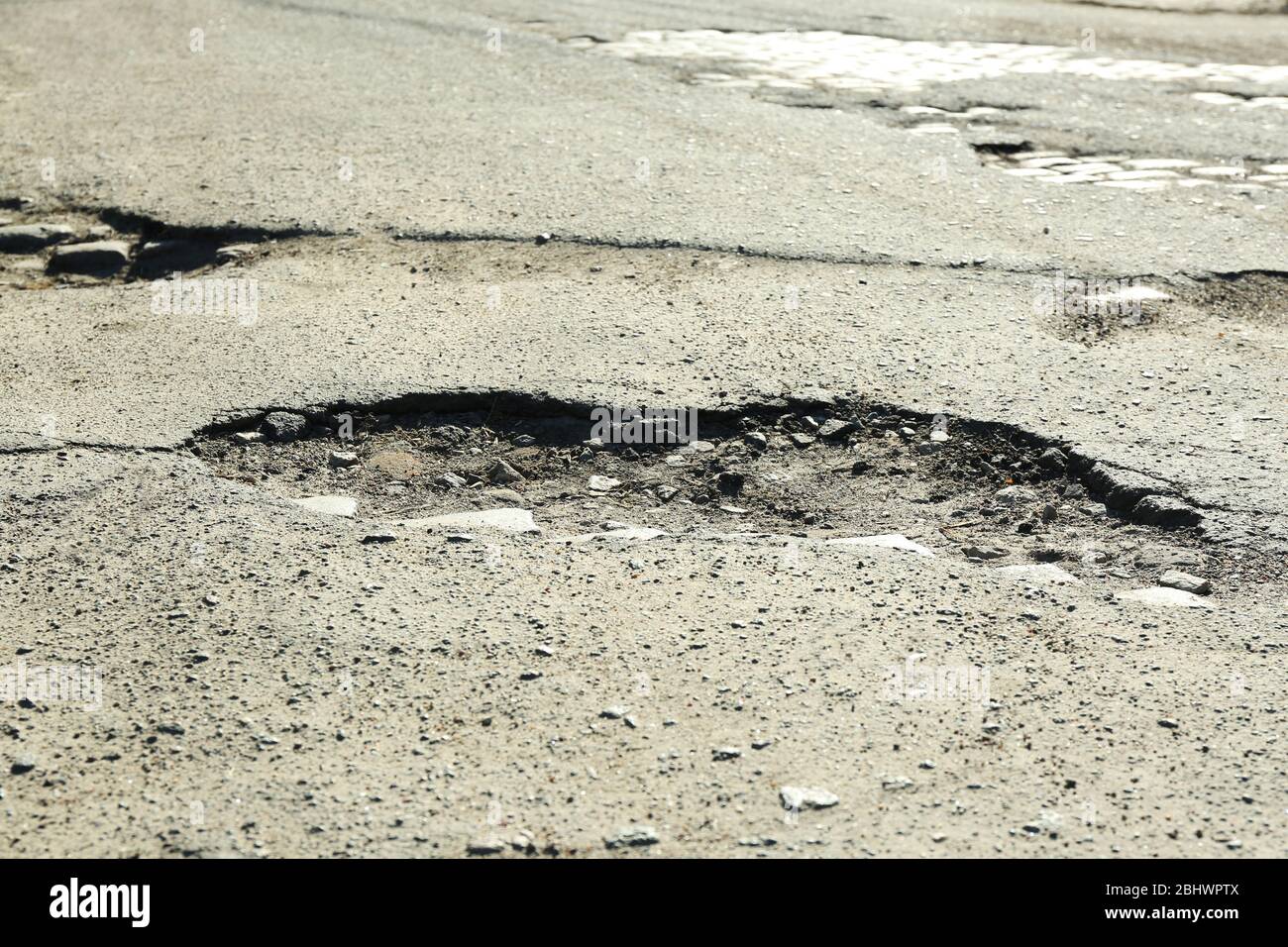 Very bad quality road with potholes Stock Photo - Alamy