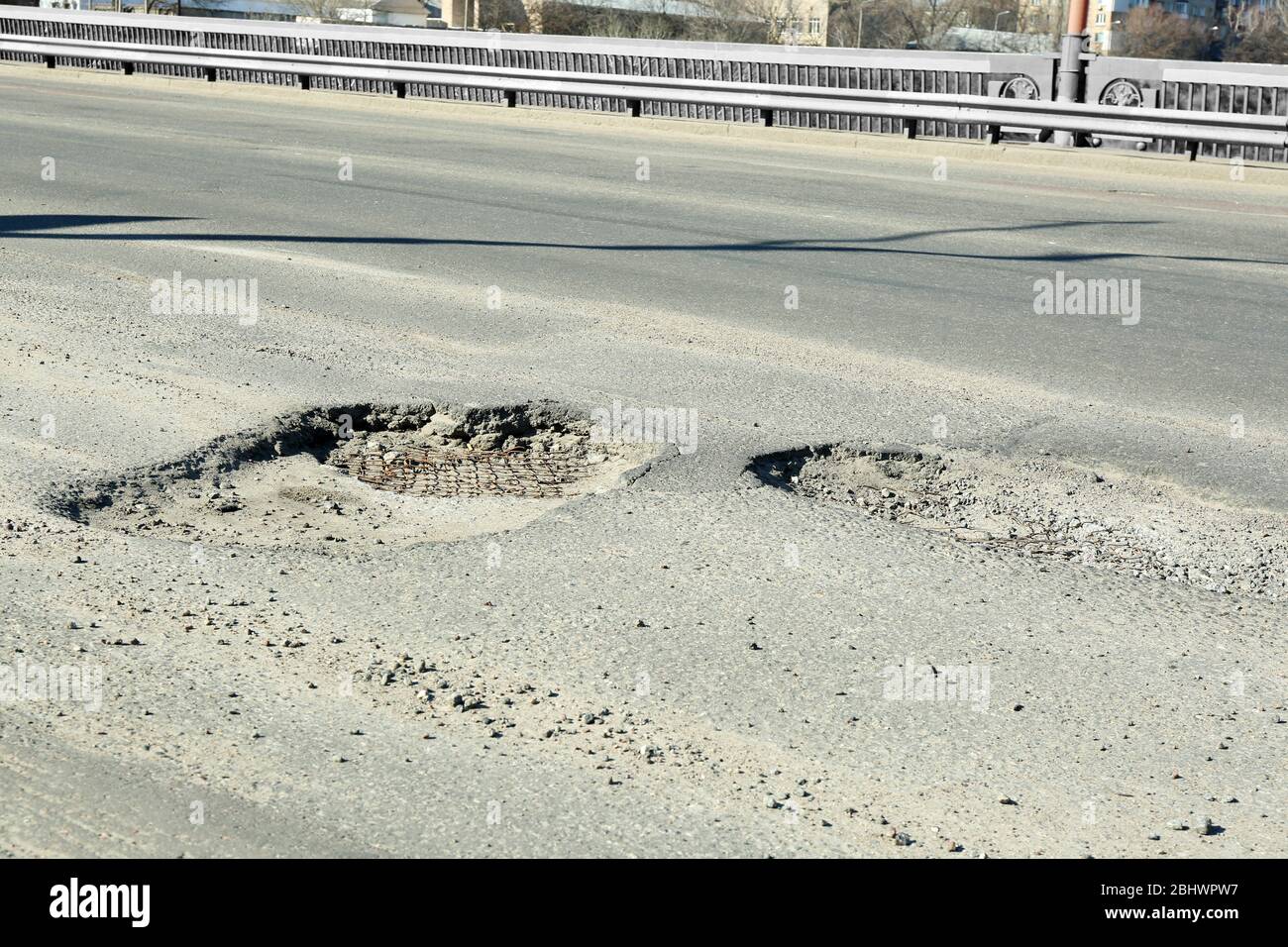 Very bad quality road with potholes Stock Photo - Alamy