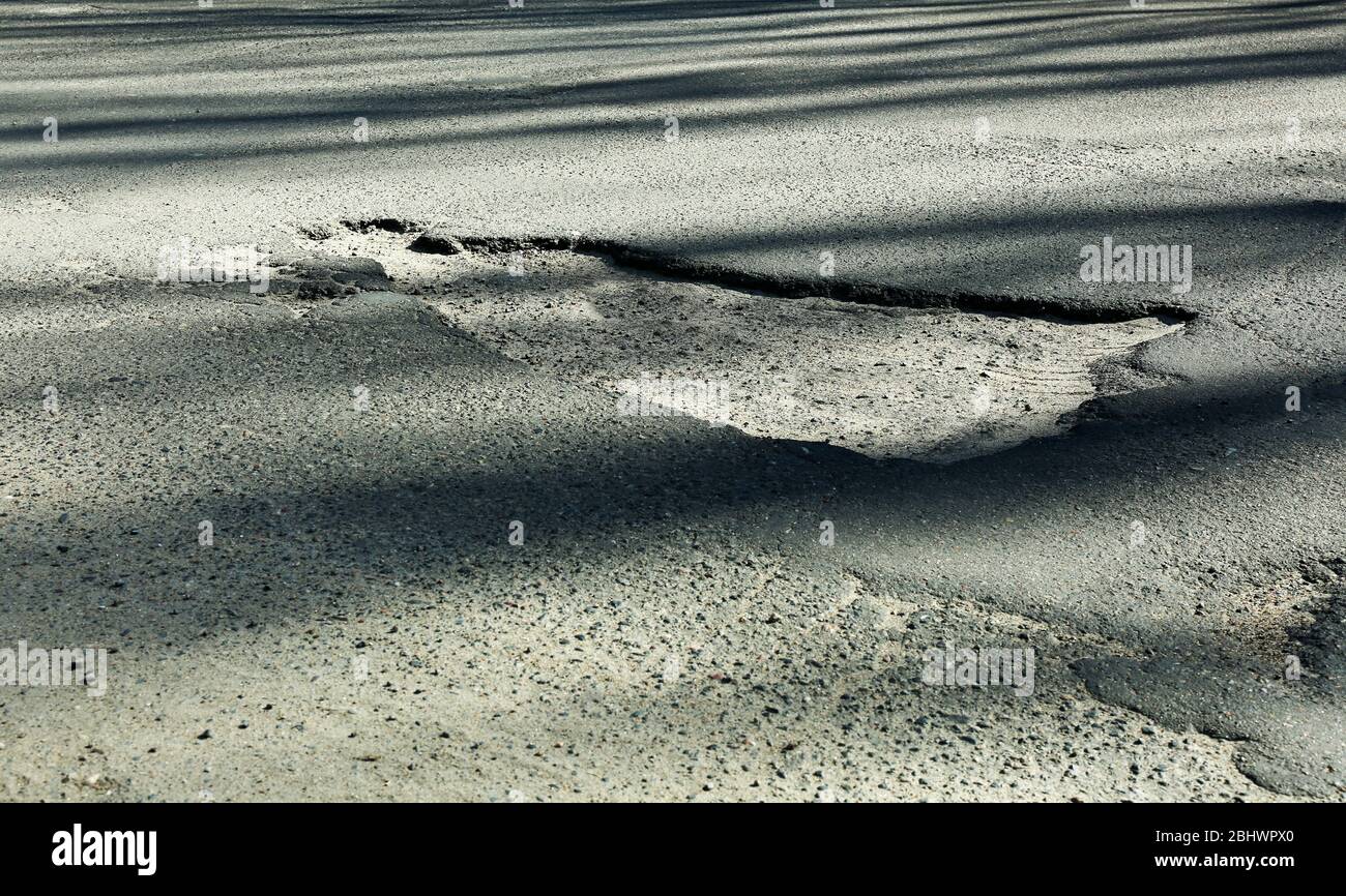 Very bad quality road with potholes Stock Photo - Alamy