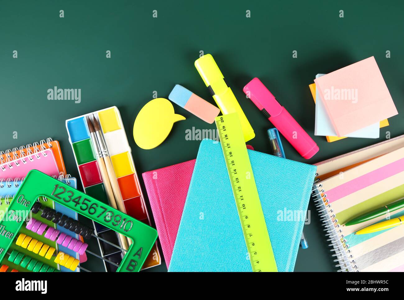 Bright school supplies on blackboard background Stock Photo - Alamy