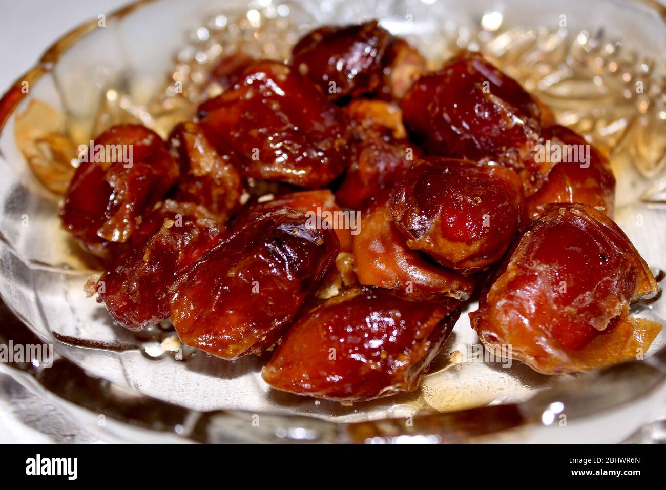 delicious dried date palm fruits cut pieces in glass bowl Stock Photo ...