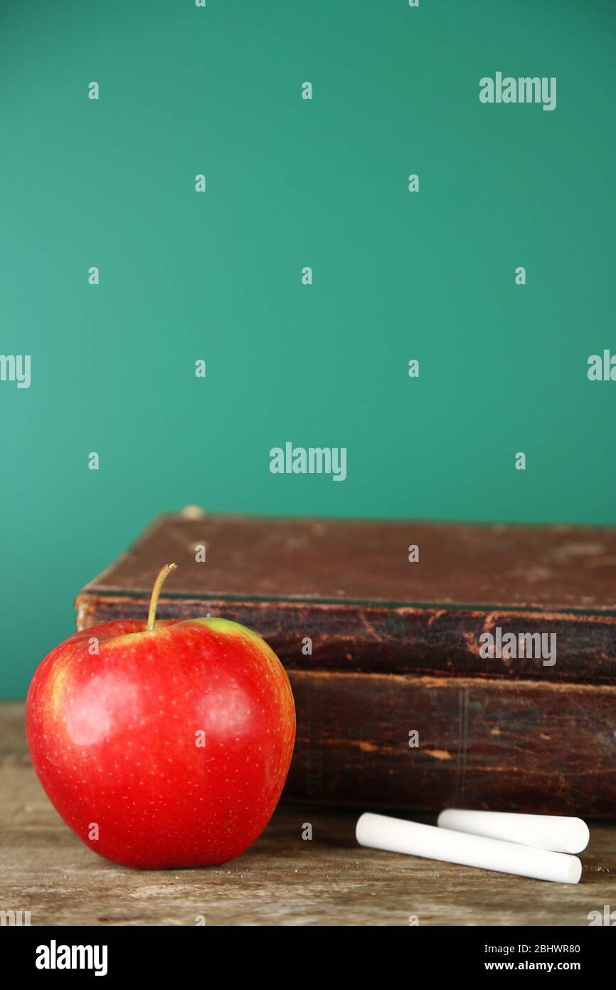 Old books, apple and chalk on blackboard background Stock Photo - Alamy