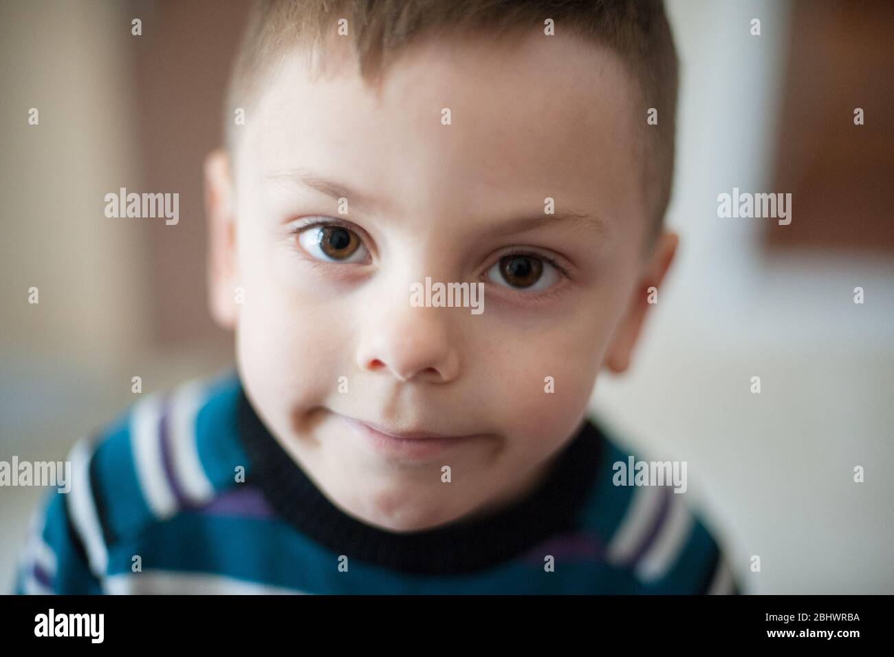 confusion smile on little boy face in sweater Stock Photo - Alamy