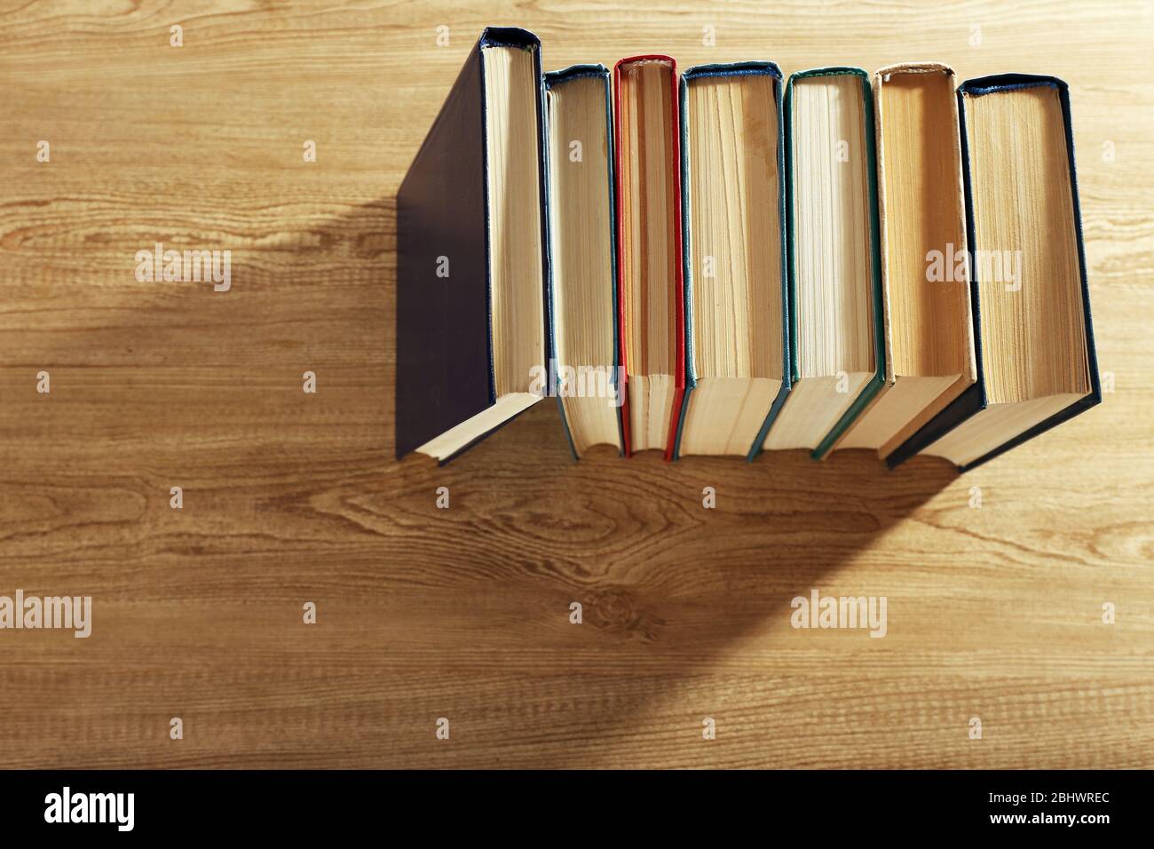 Old books on wooden table, top view Stock Photo - Alamy