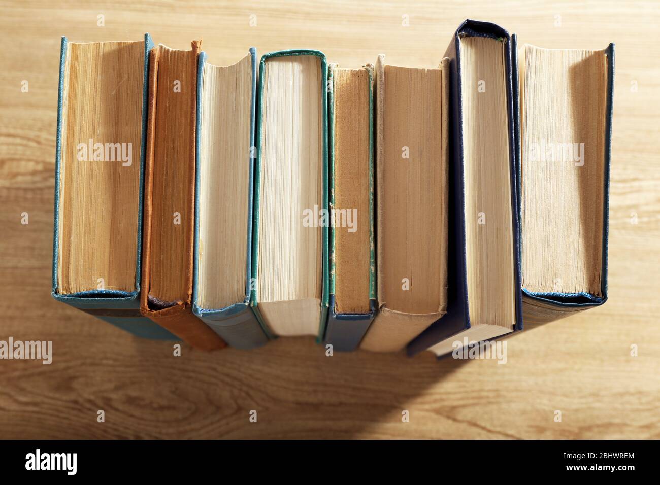 Old books on wooden table, top view Stock Photo - Alamy