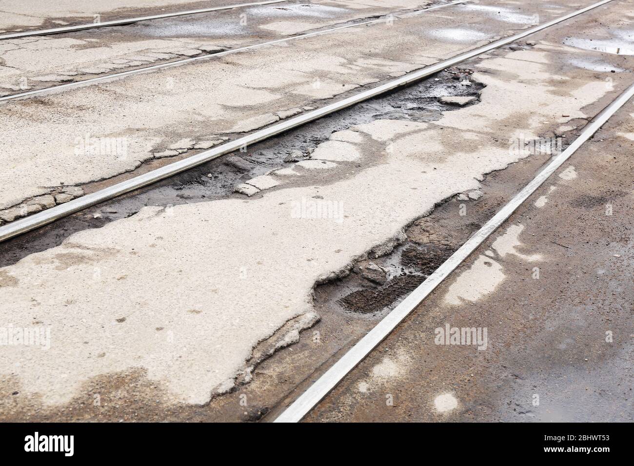 Very bad quality road with potholes and puddles Stock Photo - Alamy