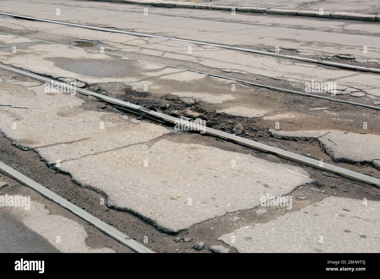 Very bad quality road with potholes and puddles Stock Photo - Alamy