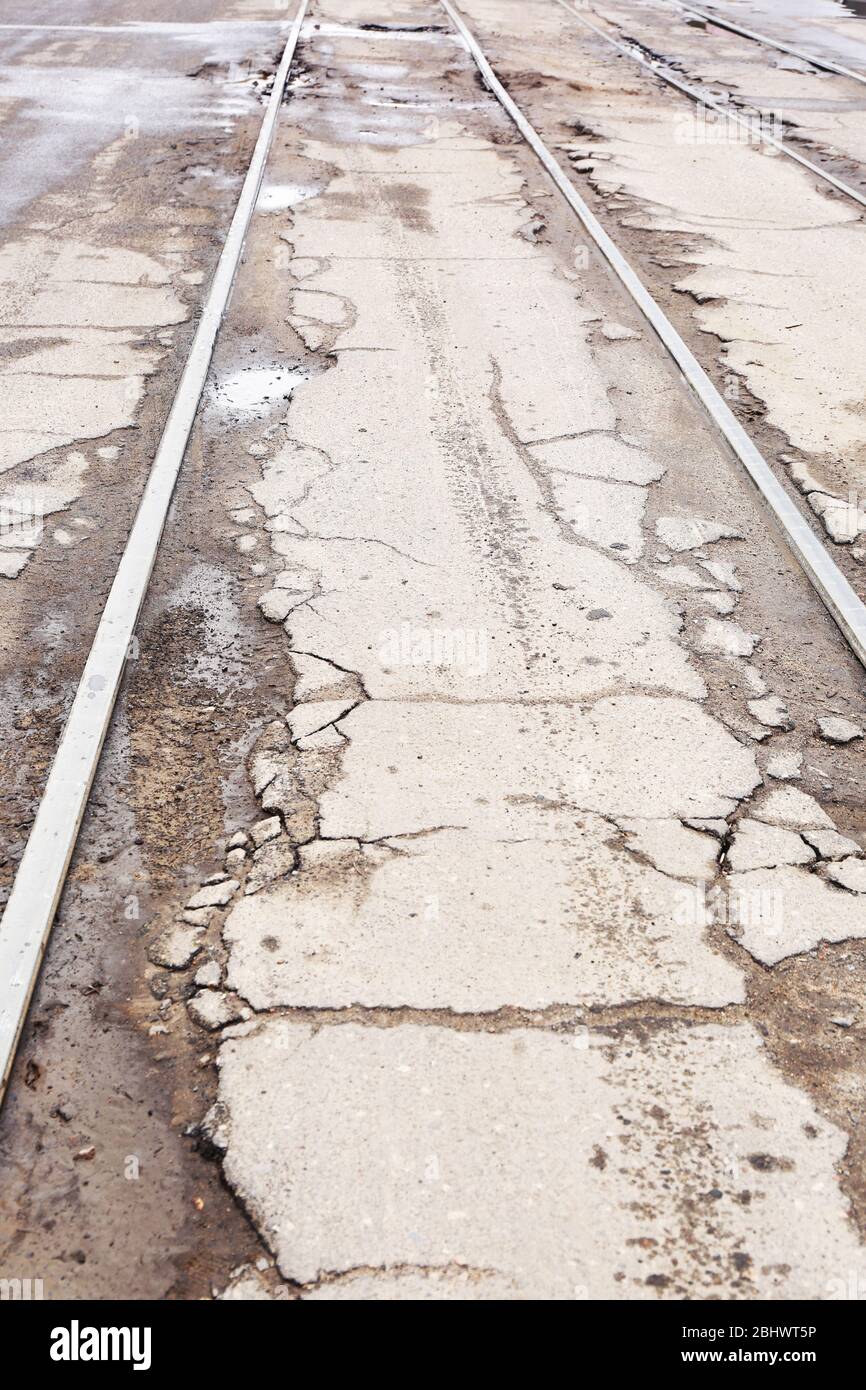 Very bad quality road with potholes and puddles Stock Photo - Alamy