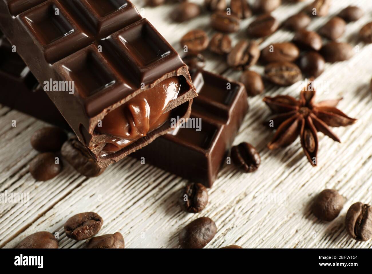 Stuffed chocolate with coffee beans on wooden table, closeup Stock ...